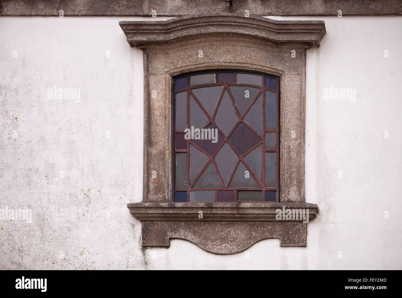 A classical stained glass window in the gothic style is beautifully ...