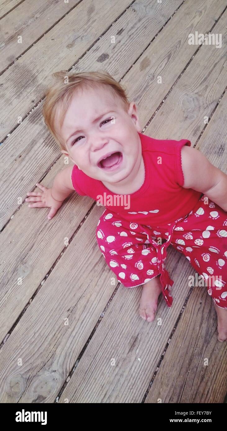 High Angle Portrait Of Toddler Girl Crying On Boardwalk Stock Photo - Alamy