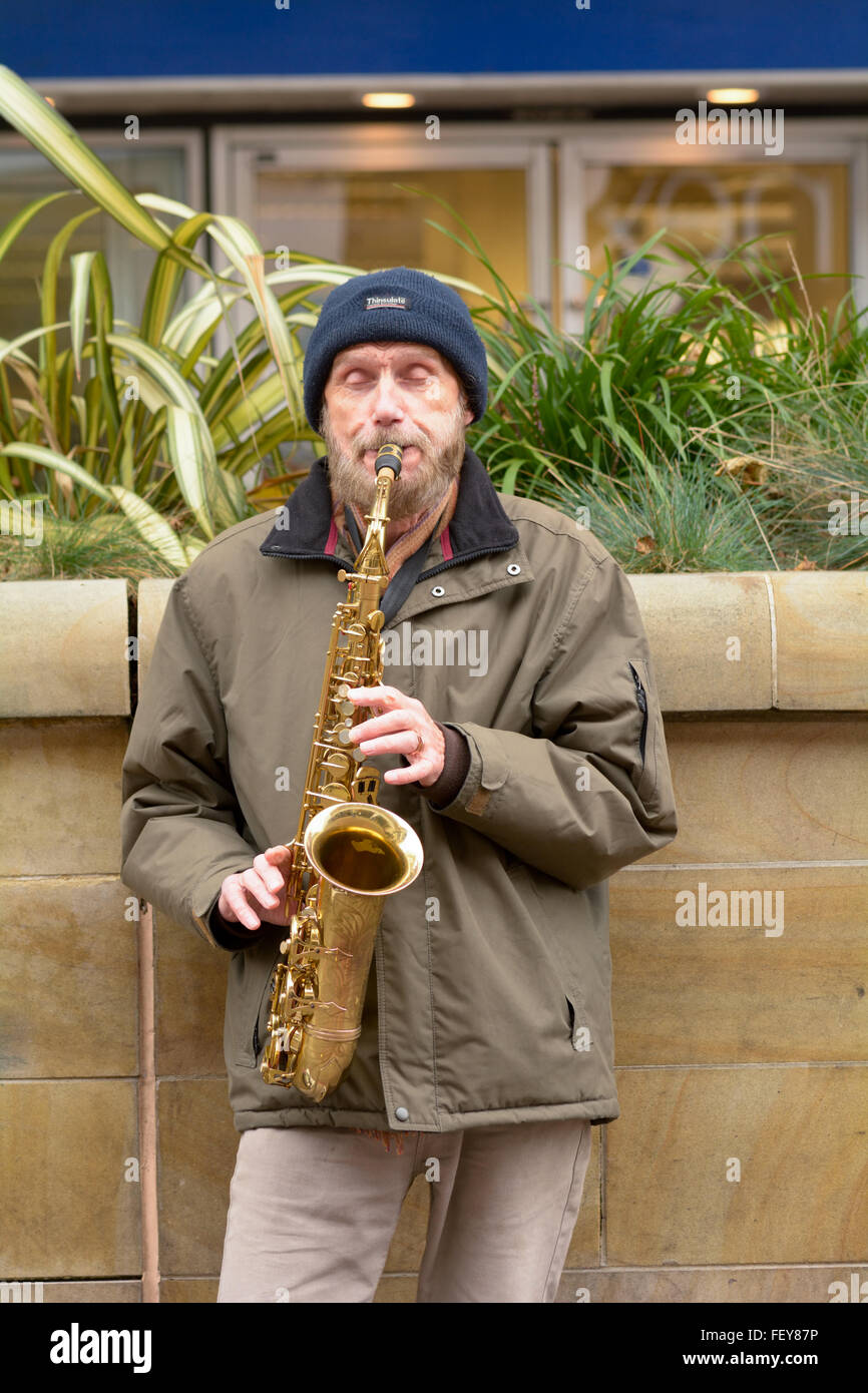 Busker playing saxophone hi-res stock photography and images - Alamy