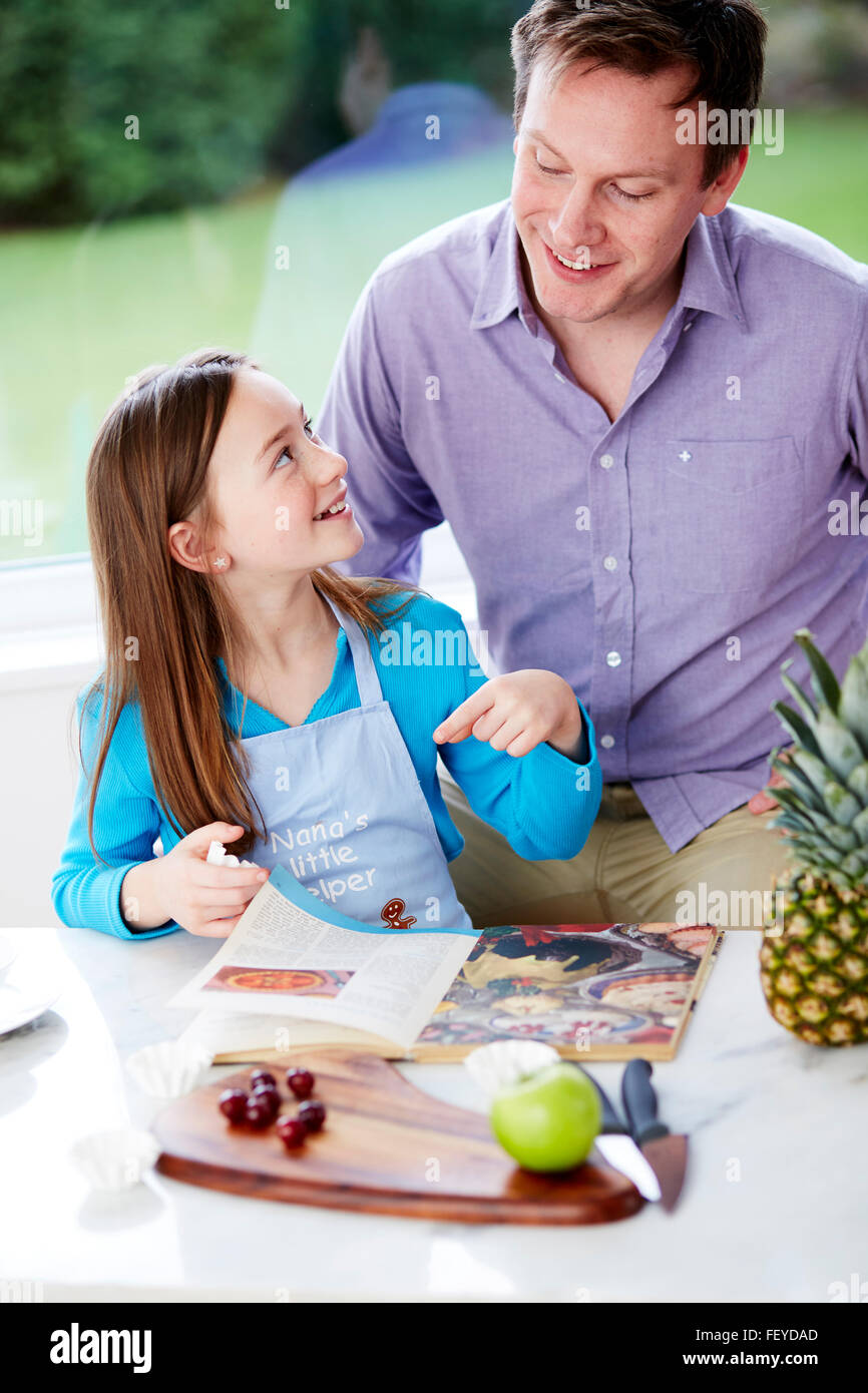 Child preparing food with parents Stock Photo - Alamy