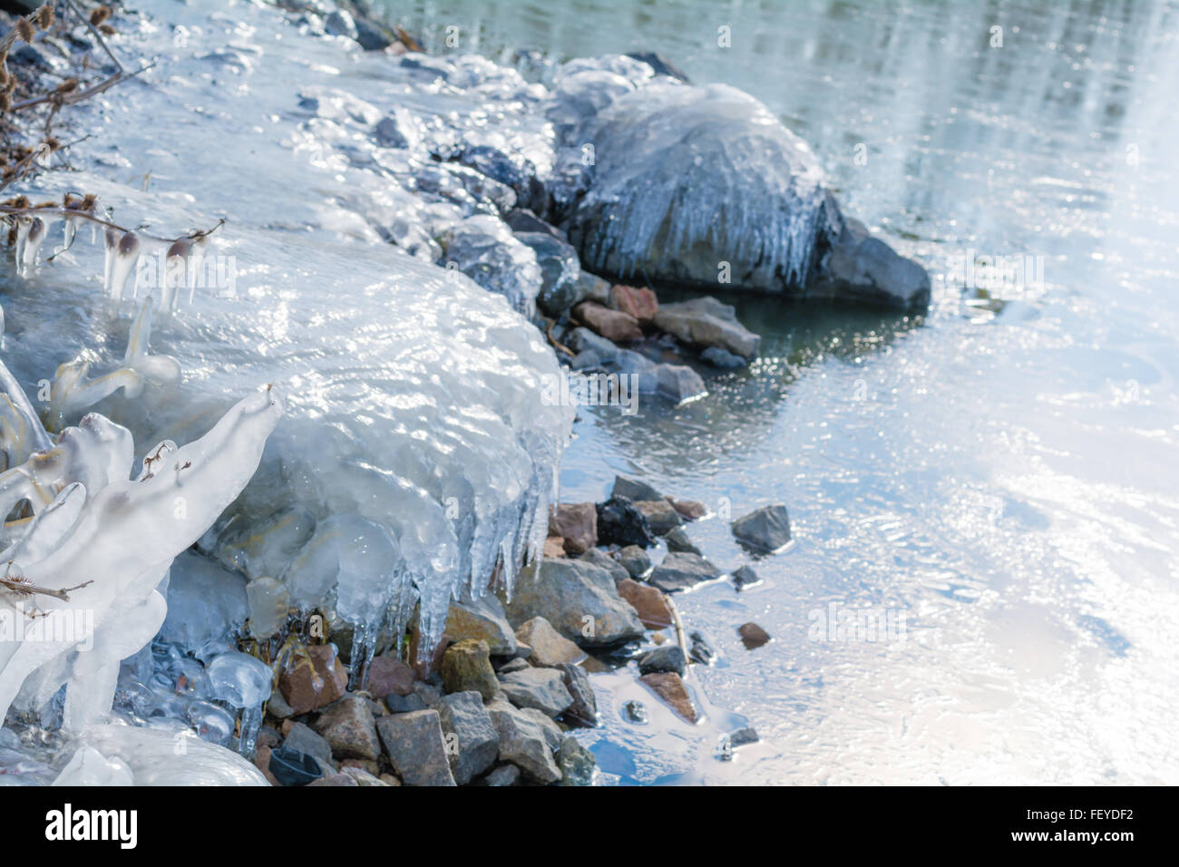 Frozen rocks with ice in the winter lake Stock Photo - Alamy