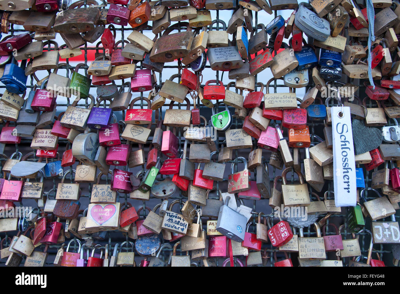 Europe, Germany, Cologne, padlocks on fence of footpath of the ...