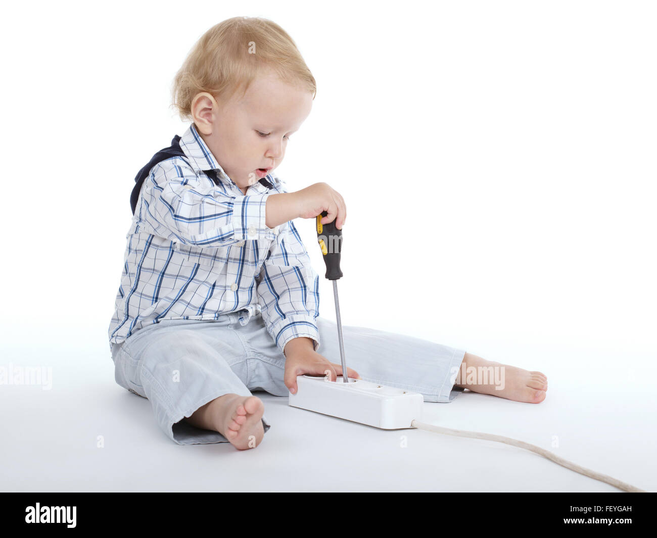 boy plays with plug and screwdriver Stock Photo - Alamy