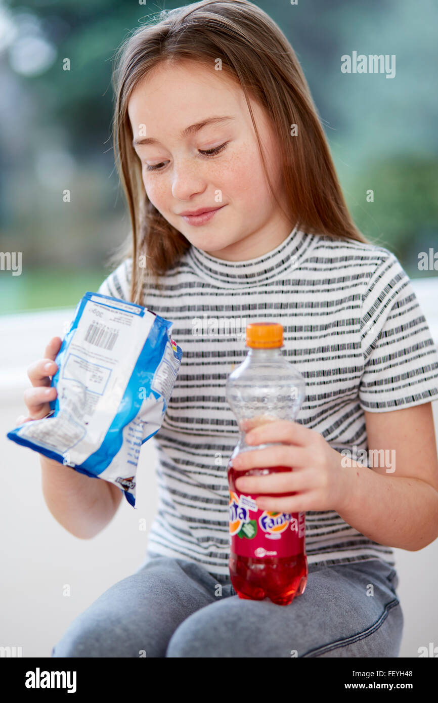 Girl eating crisps Stock Photo - Alamy