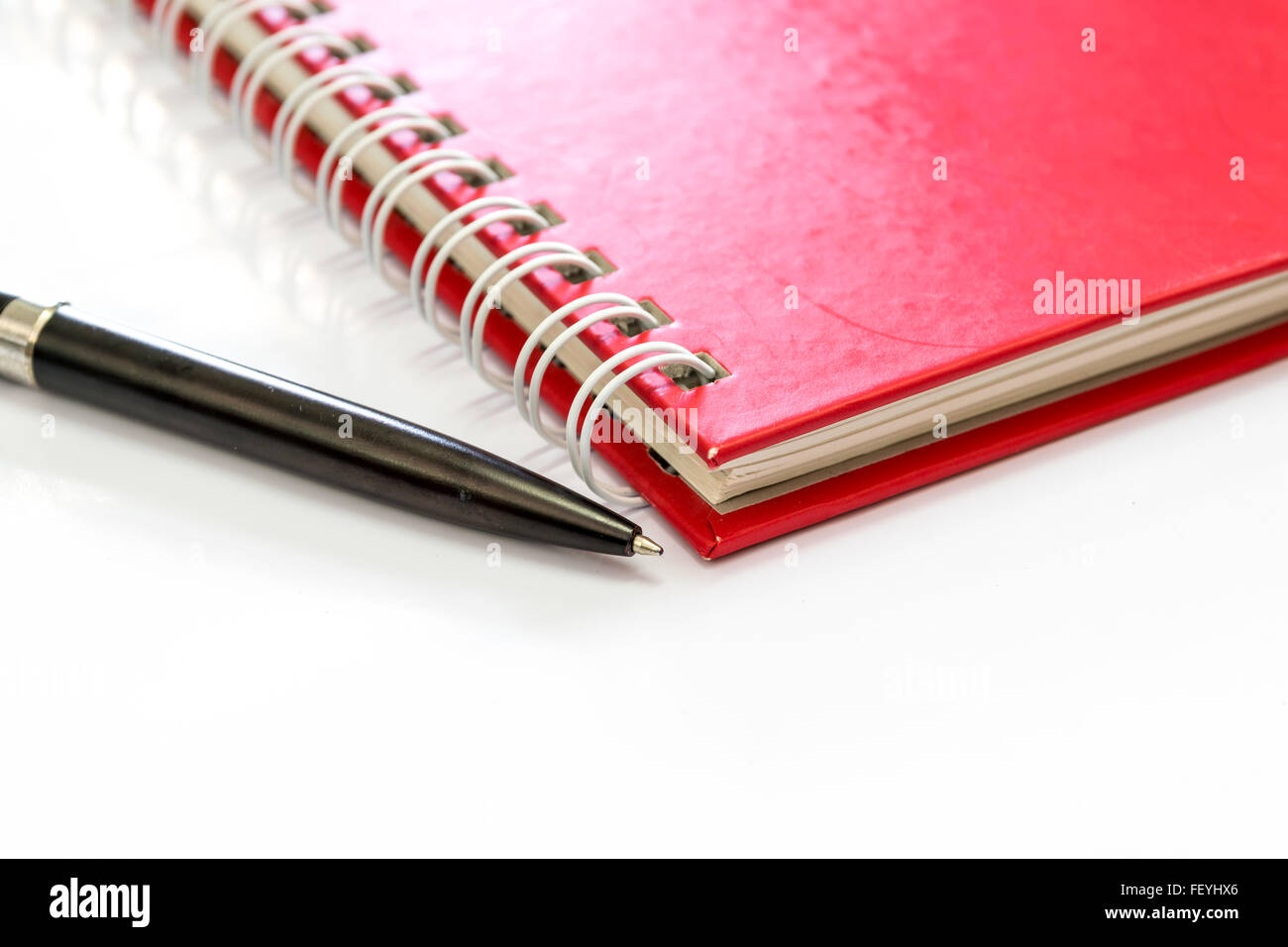 Colorful note book and pen isolated on white background Stock Photo - Alamy