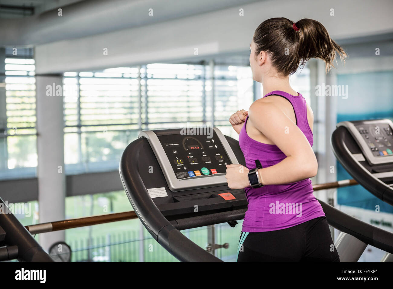 Fti brunette running on treadmill Stock Photo - Alamy