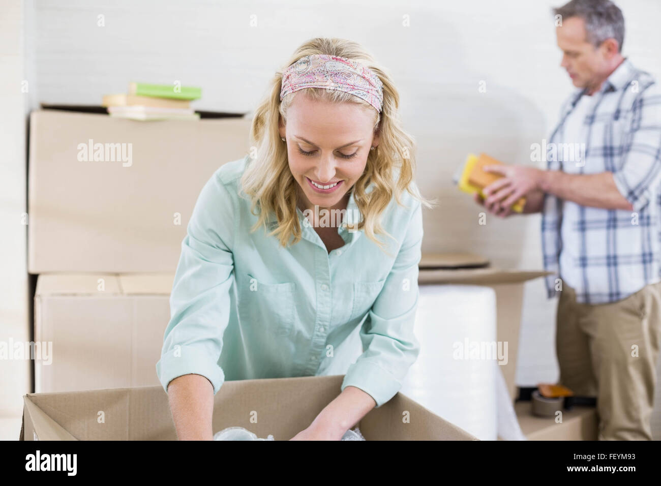 Woman packing moving box hi-res stock photography and images - Alamy