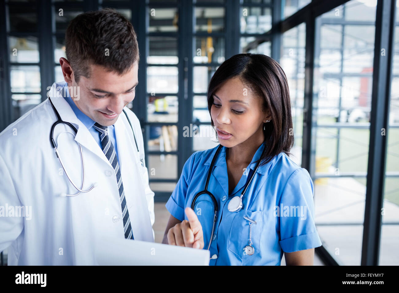 Nurse and doctor looking at files Stock Photo - Alamy