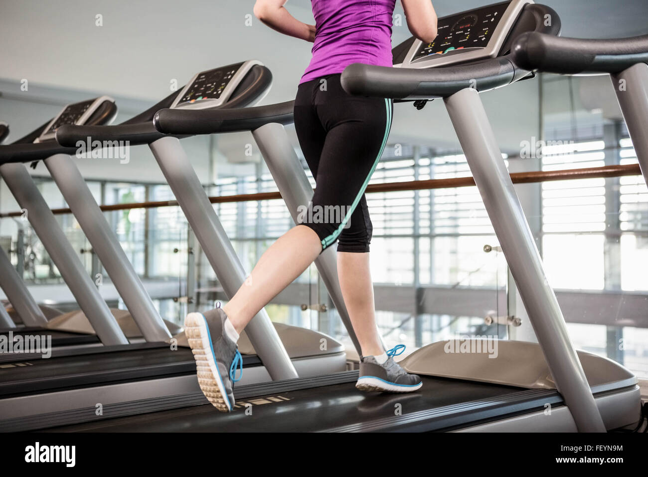 Lower section of fit woman on treadmill Stock Photo - Alamy
