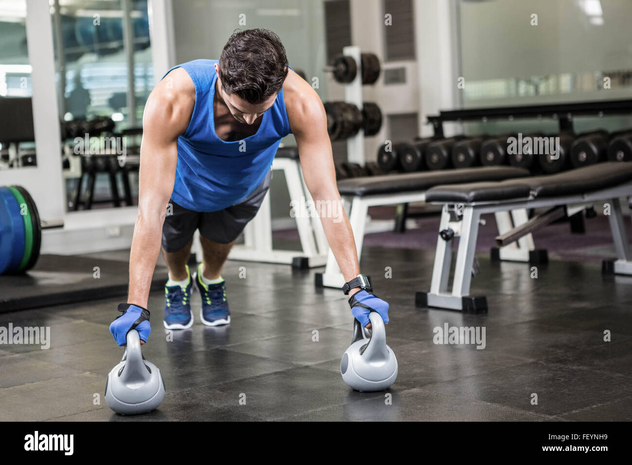 handsome man doing push ups with kettlebells Stock Photo - Alamy