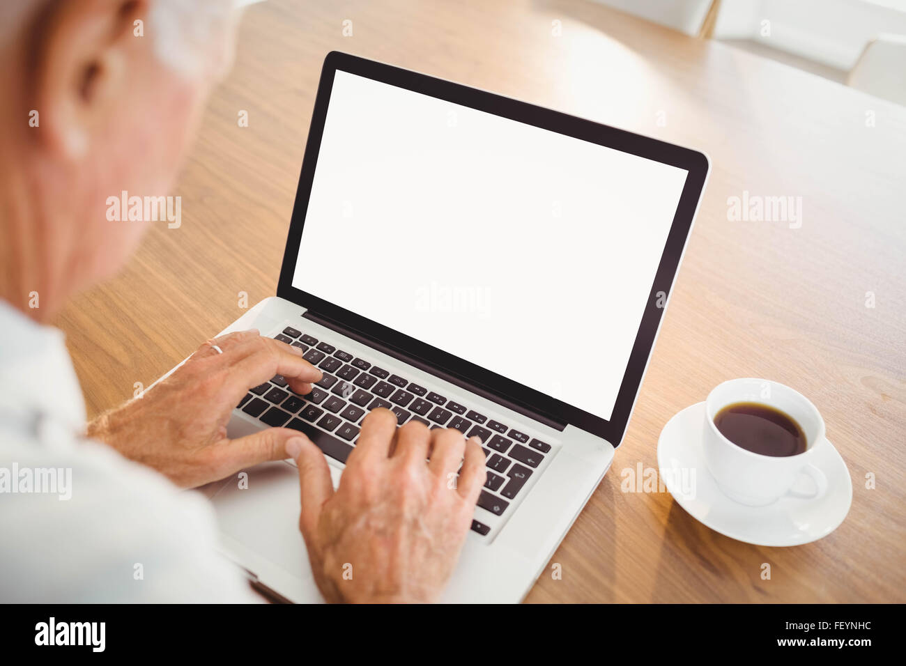 Focused elderly man typing on laptop Stock Photo - Alamy