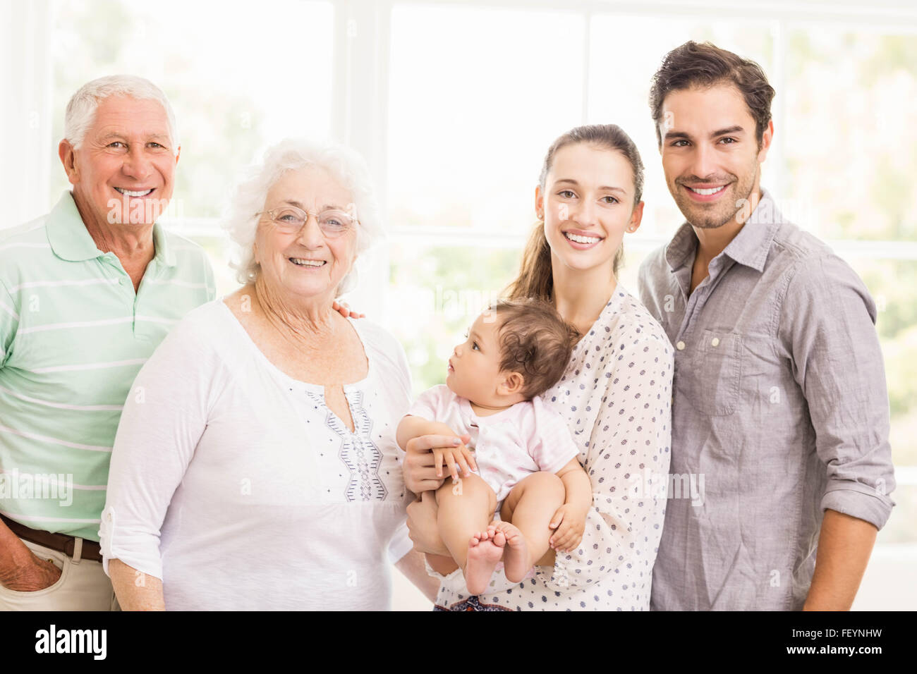 Happy extended family smiling Stock Photo - Alamy