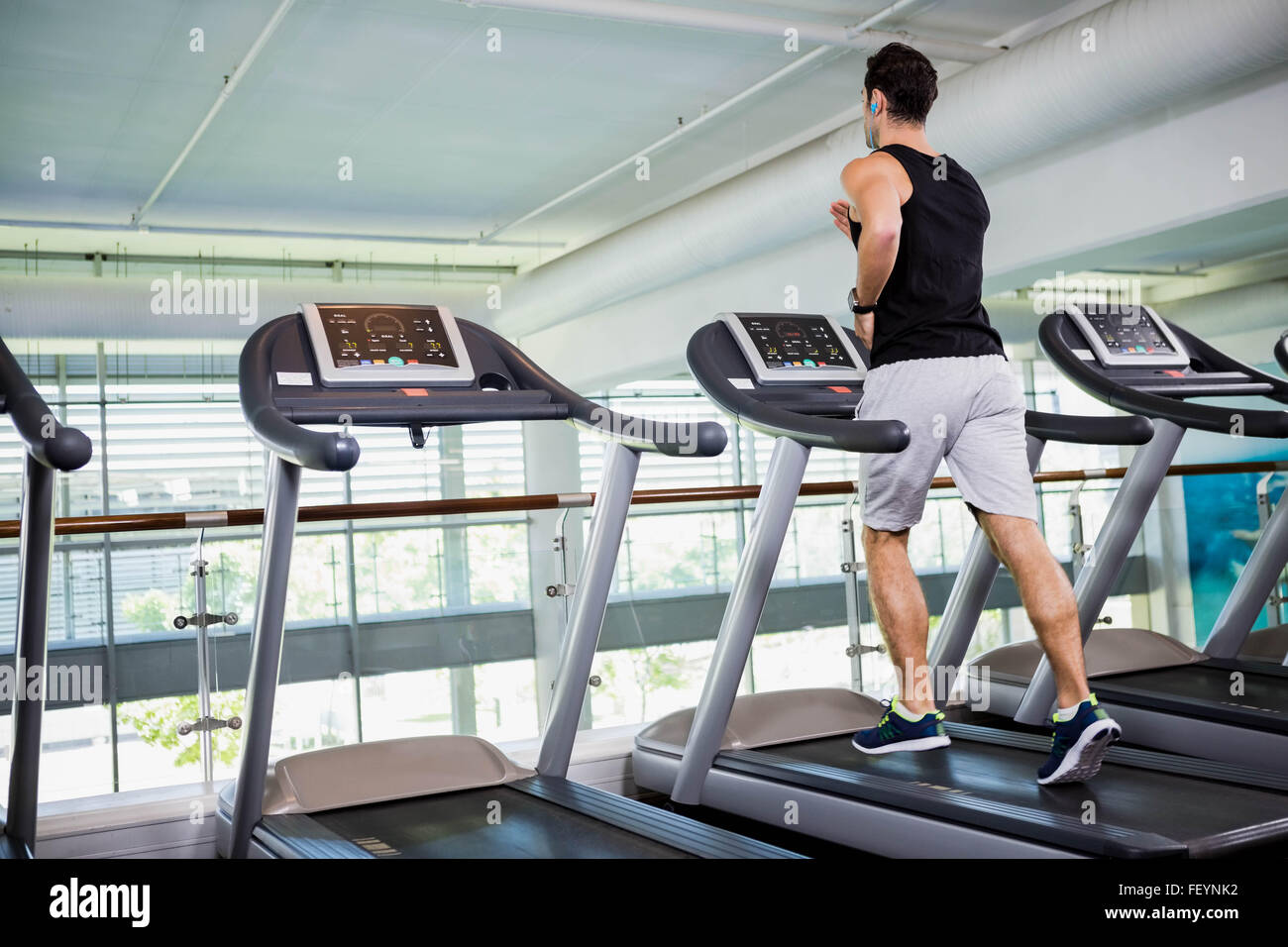 Fit man running on treadmill Stock Photo - Alamy
