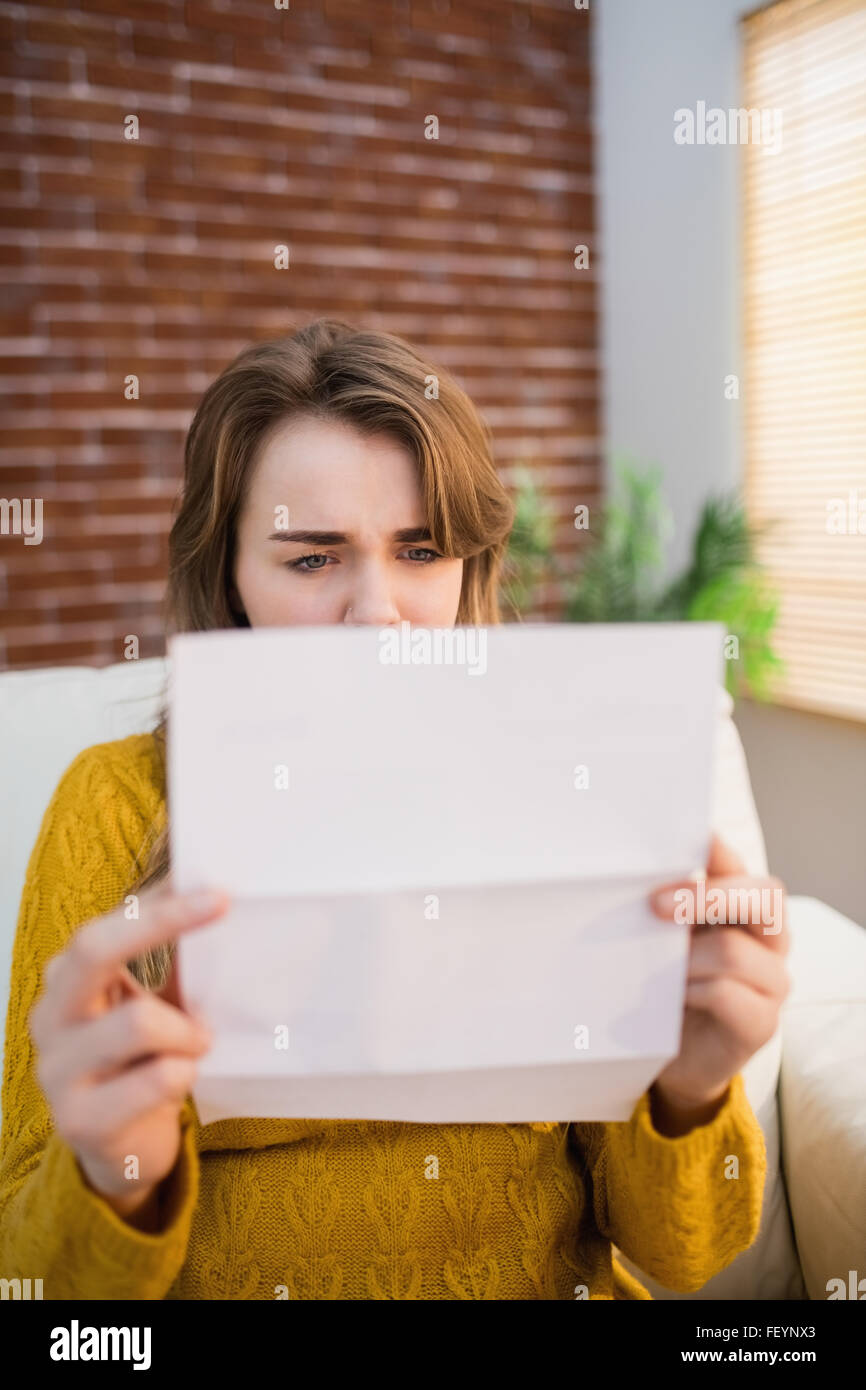 Upset woman looking at bill Stock Photo - Alamy
