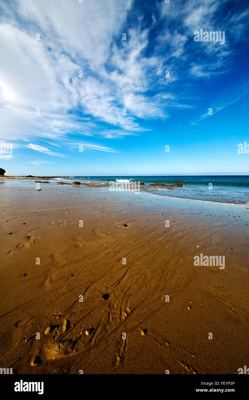 footstep in lanzarote spain rock stone sky cloud beach water musk pond ...