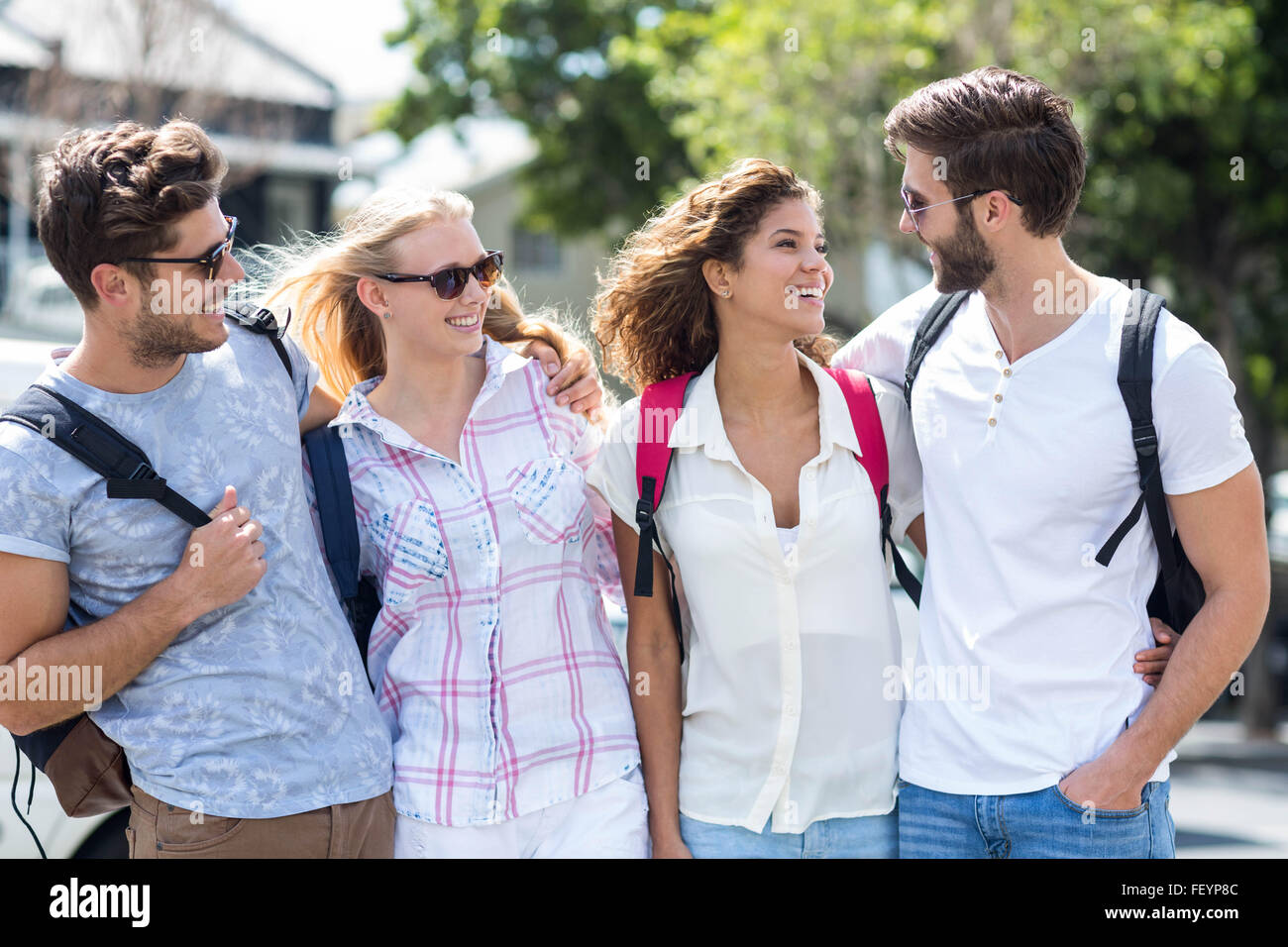 Hip friends talking and smiling Stock Photo - Alamy
