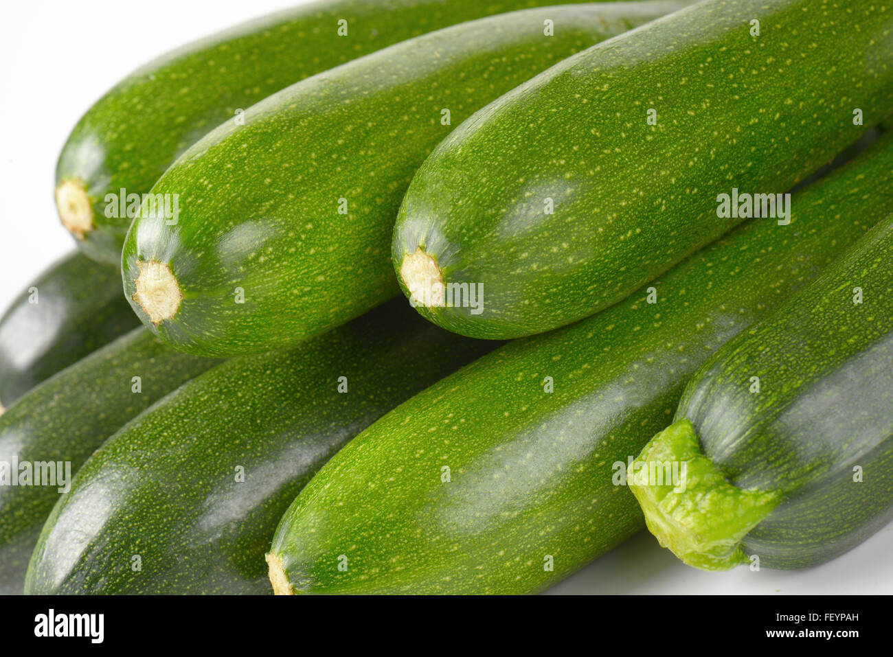 detail of fresh courgettes on white background Stock Photo - Alamy