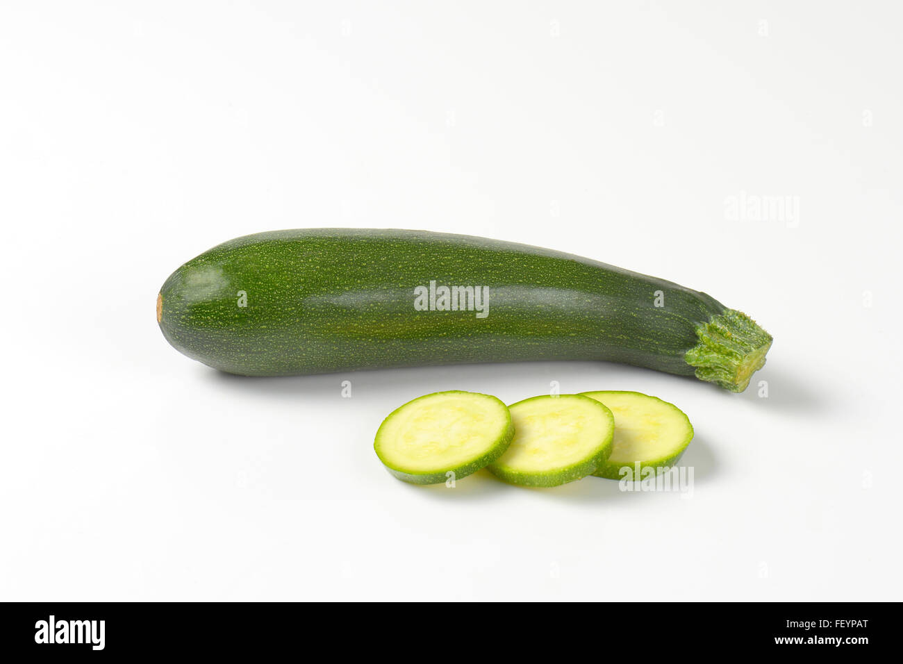 fresh courgette and courgette slices on white background Stock Photo ...