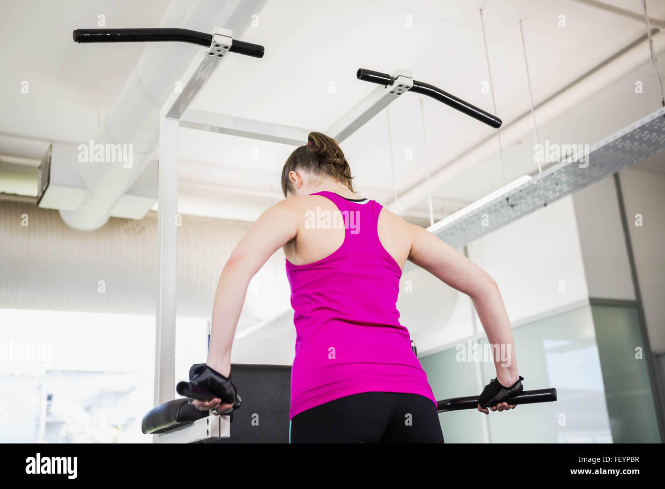 Fit woman doing pull up Stock Photo - Alamy