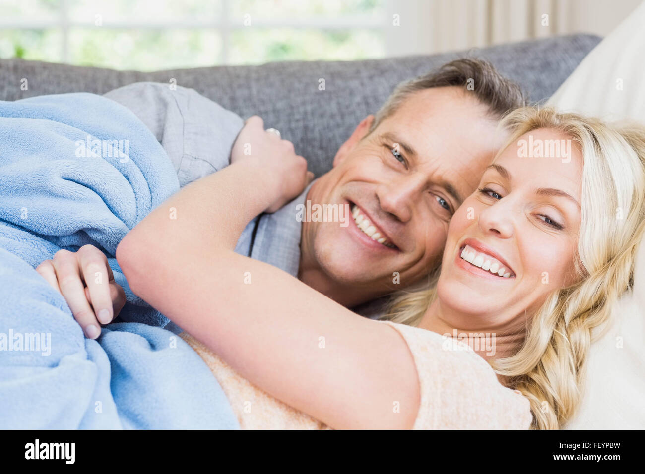 Cute couple napping on the couch Stock Photo - Alamy