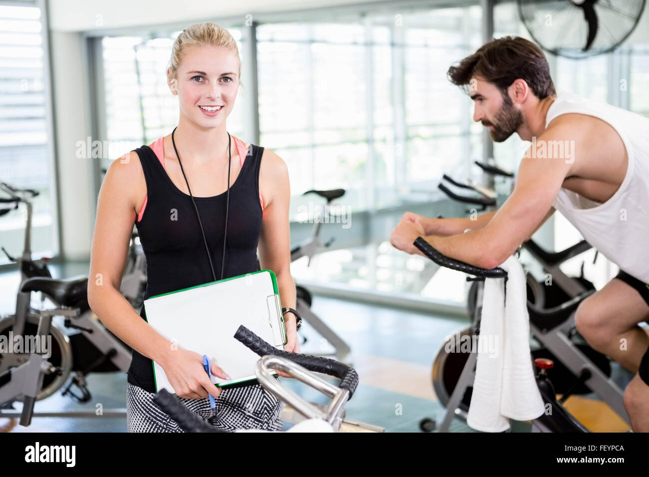 Smiling female trainer looking at the camera Stock Photo - Alamy