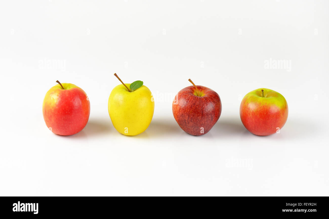 four ripe apples in a row on white background Stock Photo - Alamy