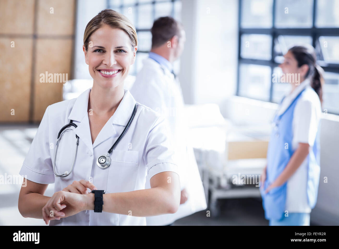 Nurse checking her smart watch Stock Photo - Alamy