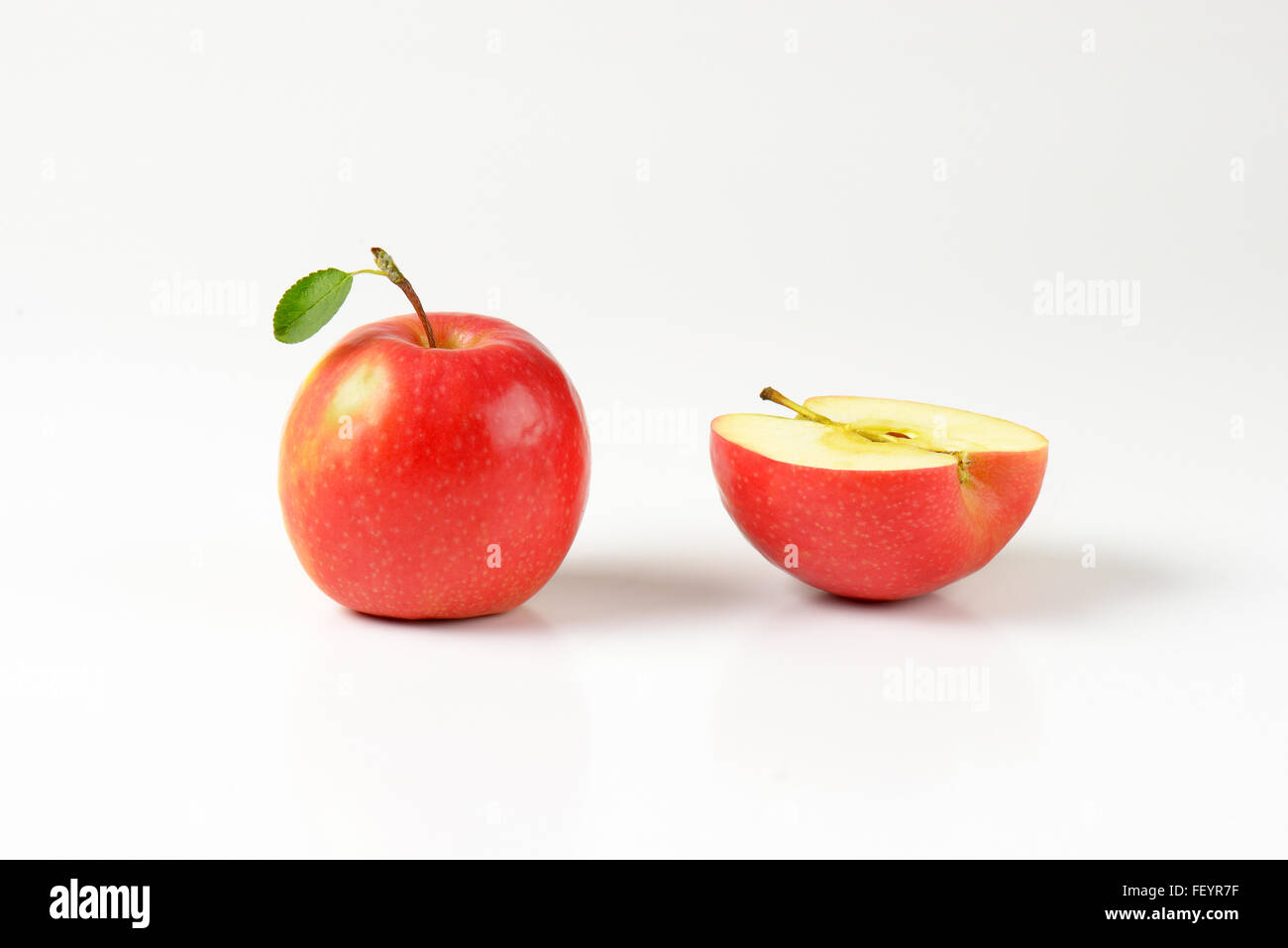 one and a half red apples on white background Stock Photo - Alamy