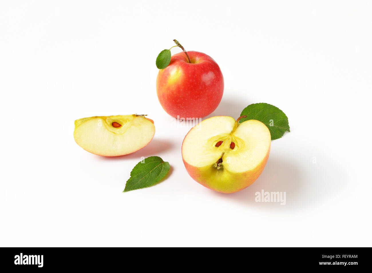 whole and sliced apples with leaves on white background Stock Photo - Alamy