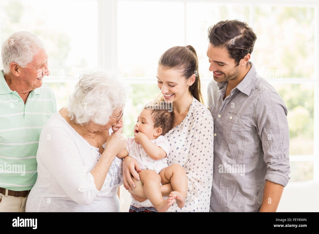 Happy extended family smiling Stock Photo - Alamy