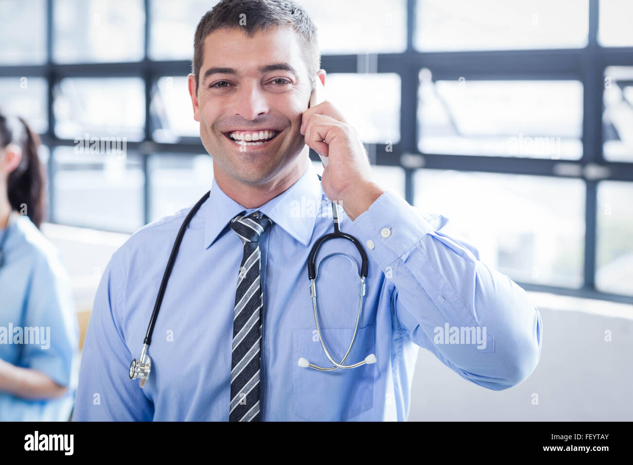 Happy doctor on the phone Stock Photo - Alamy