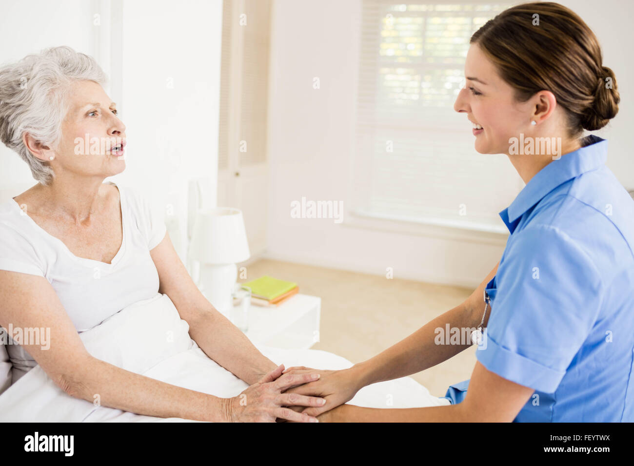 Nurse taking care of suffering senior patient Stock Photo - Alamy