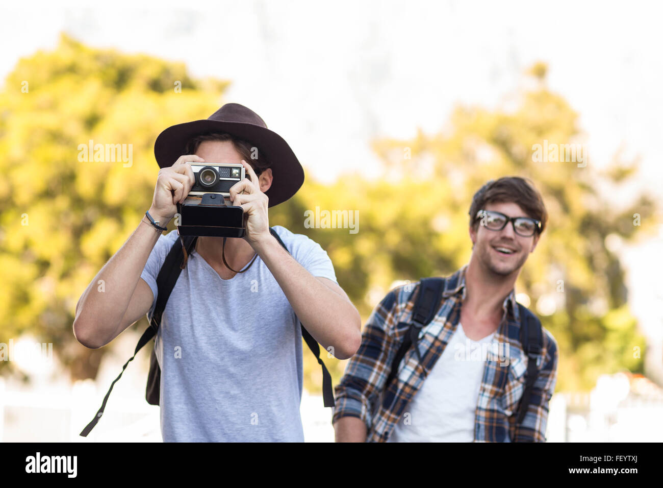 Hip man taking photo with digital camera Stock Photo - Alamy