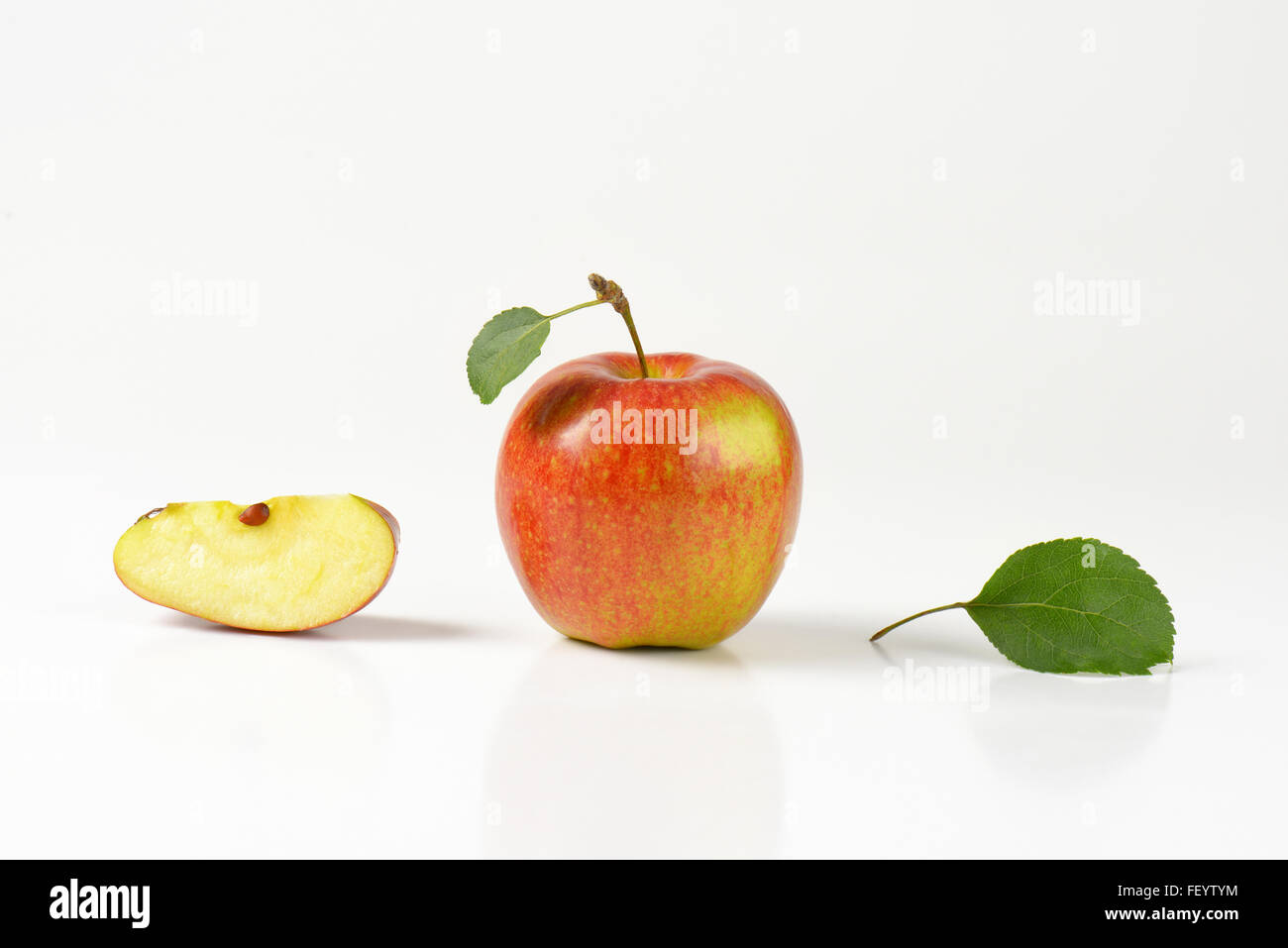 one and a quarter apples on white background Stock Photo - Alamy