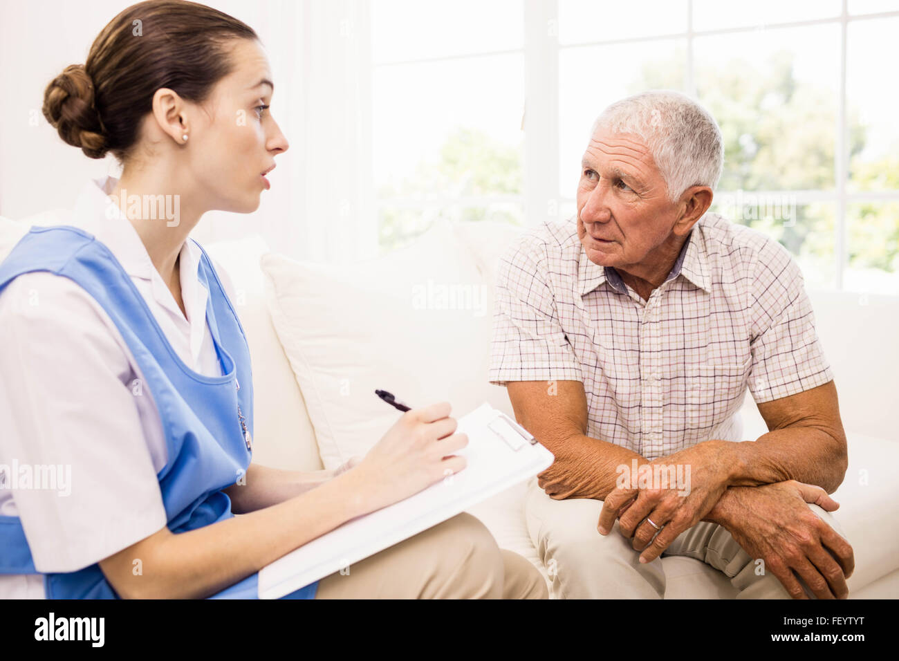 Nurse taking care of sick elderly patient Stock Photo - Alamy