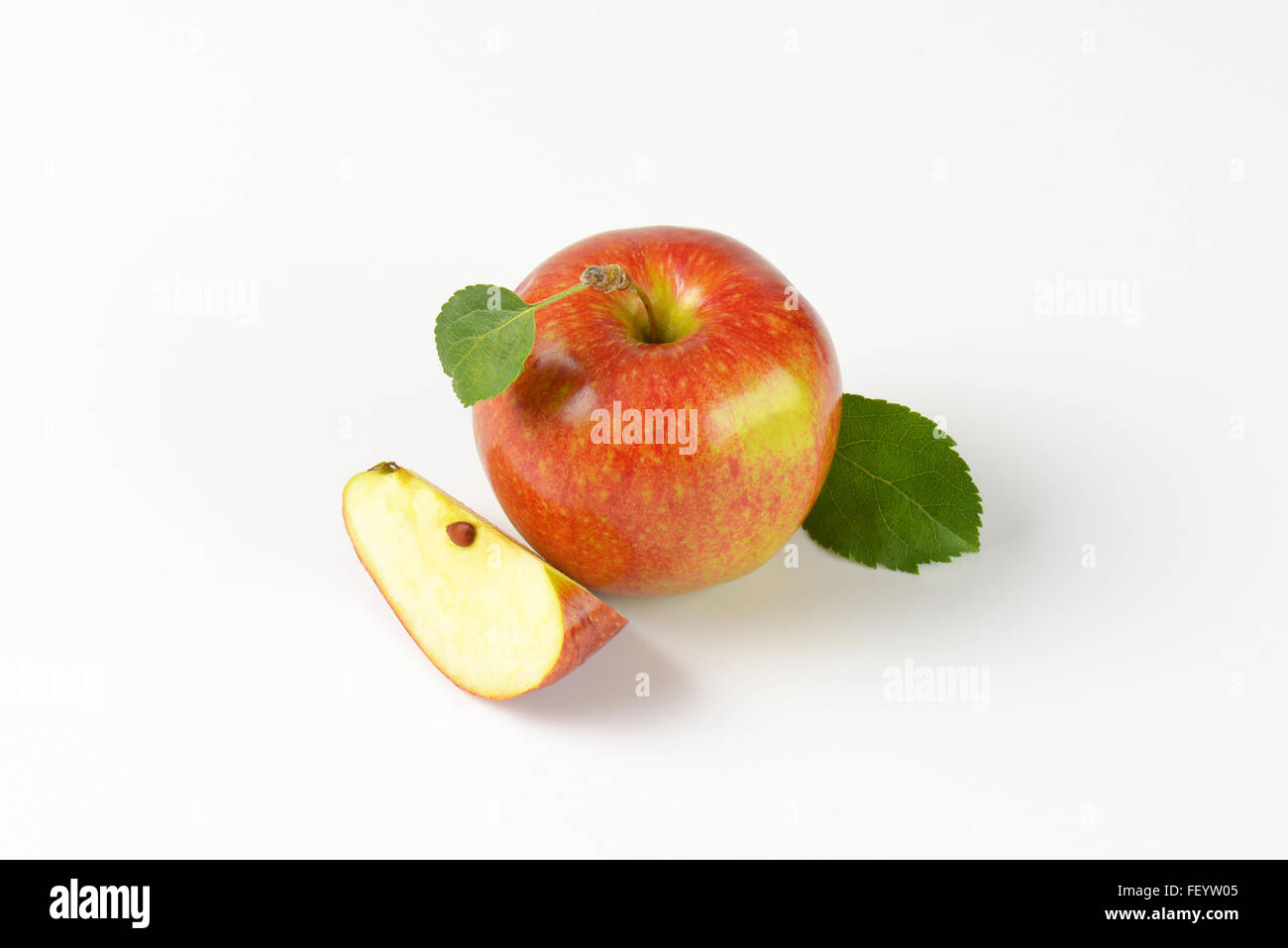 one and a quarter apples on white background Stock Photo - Alamy