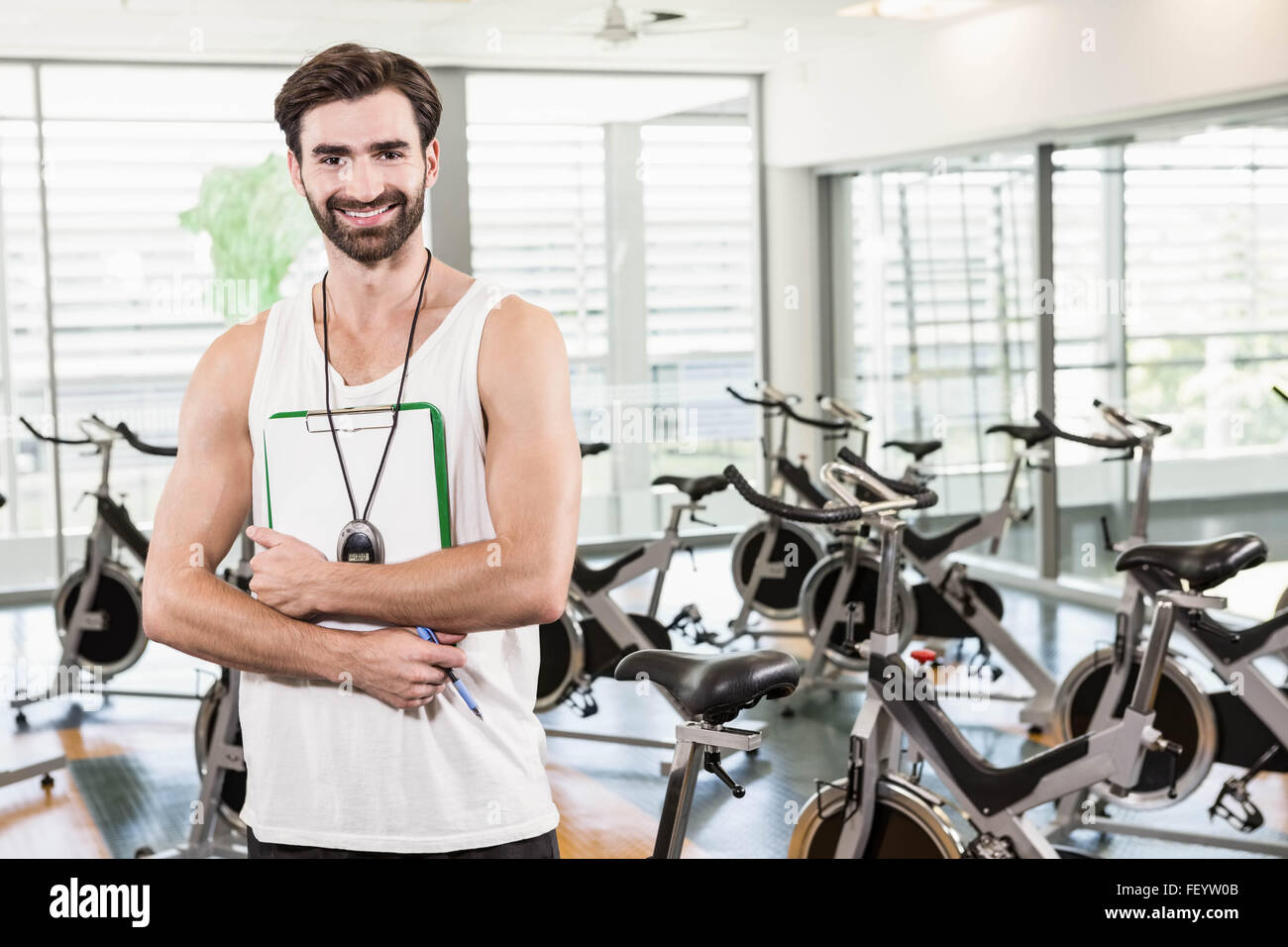 Smiling trainer looking at the camera Stock Photo - Alamy