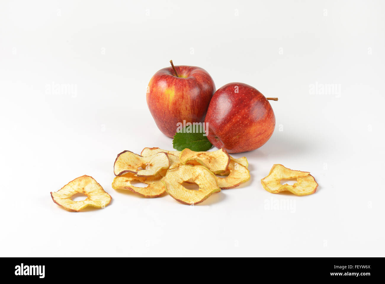 fresh red apples and dried apple rings on white background Stock Photo ...
