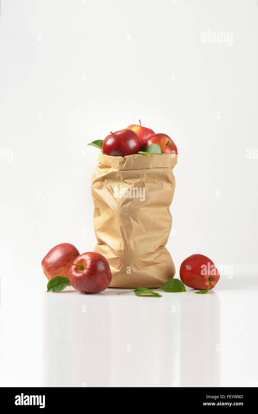 paper bag of ripe apples on white background Stock Photo - Alamy