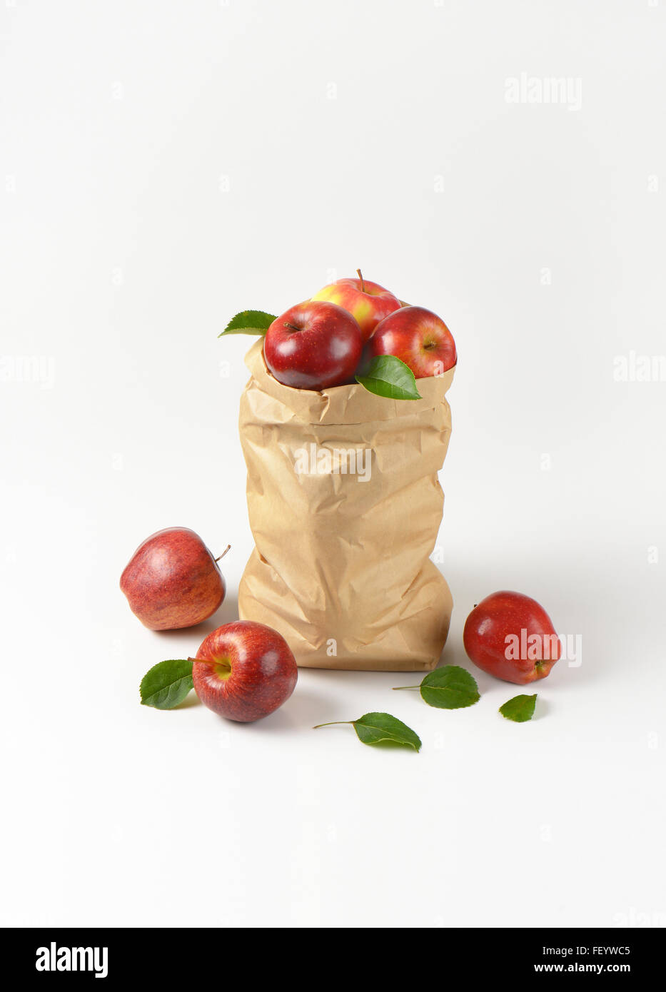 paper bag of ripe apples on white background Stock Photo - Alamy