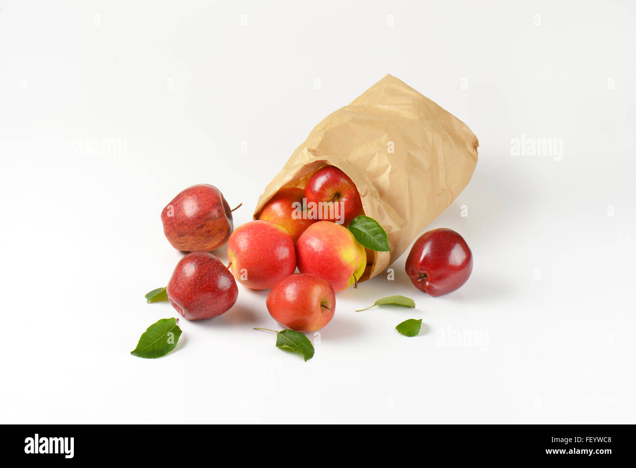 paper bag of ripe apples on white background Stock Photo - Alamy