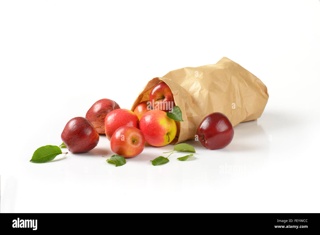 paper bag of ripe apples on white background Stock Photo - Alamy