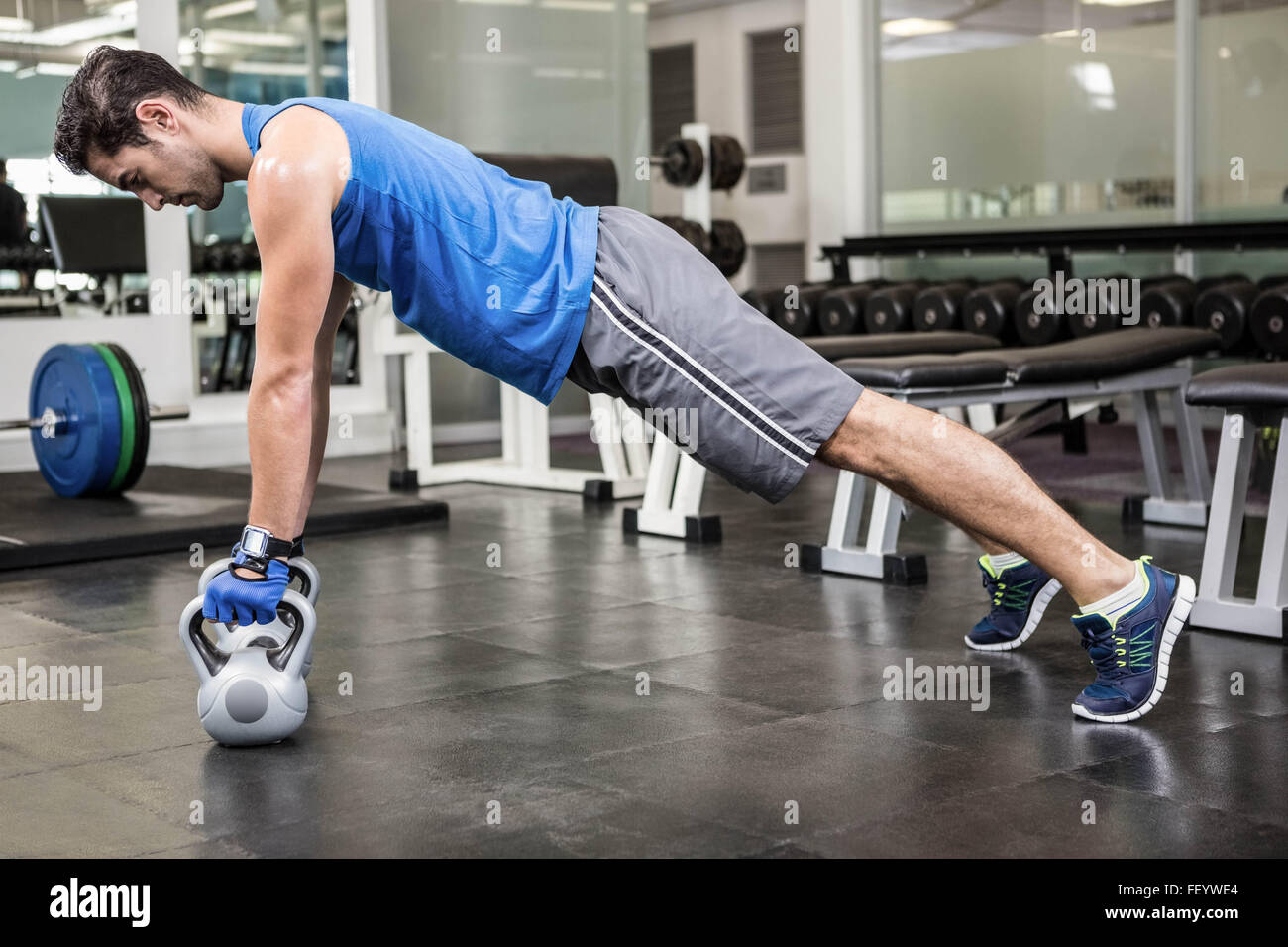 Muscular man doing push ups with kettlebells Stock Photo - Alamy