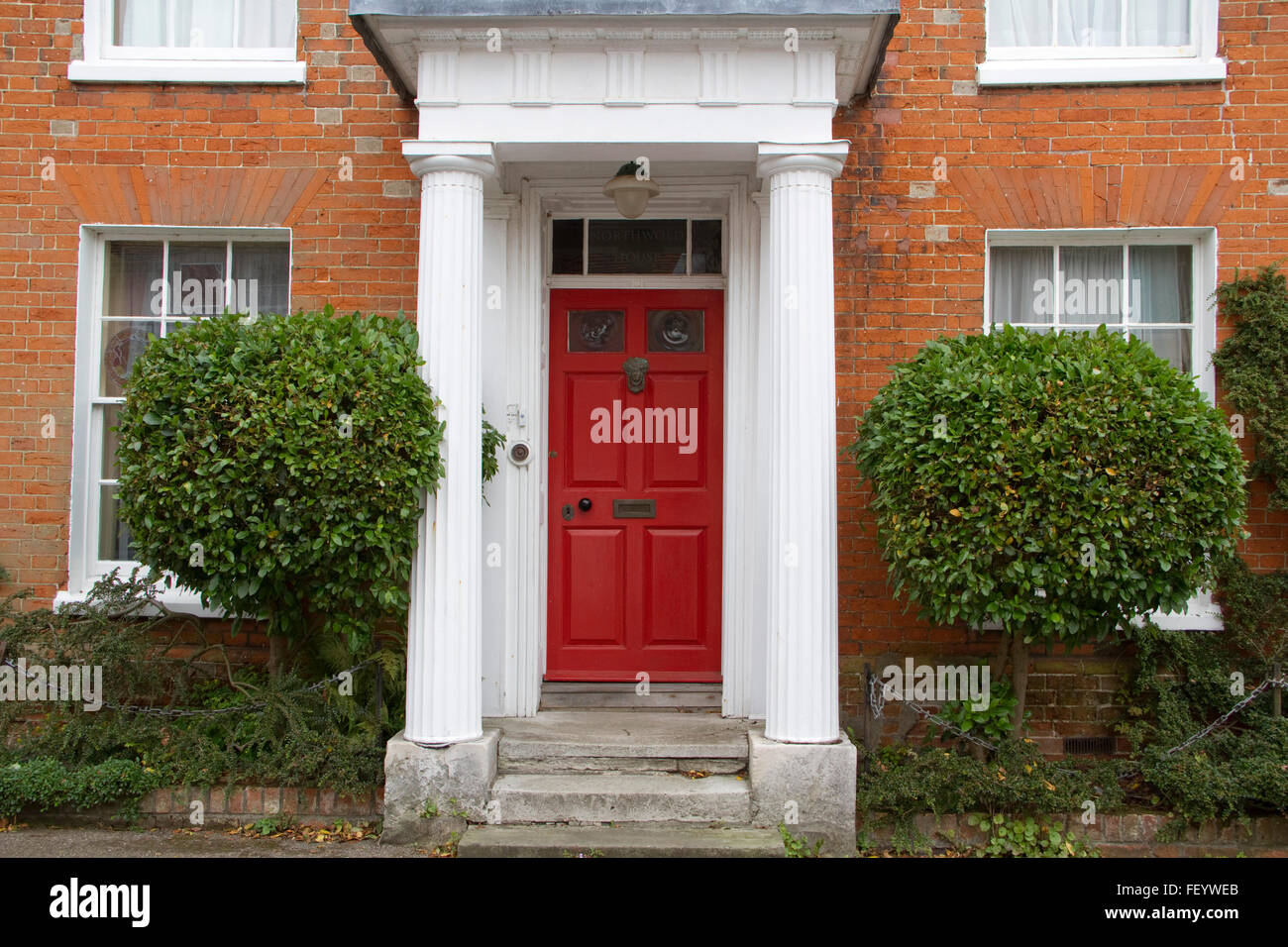 Georgian type red front door with columns Stock Photo - Alamy