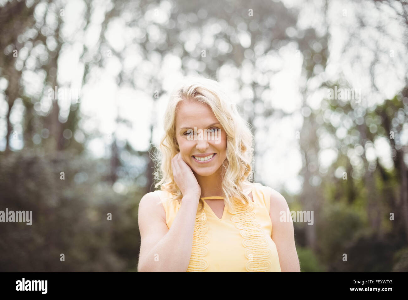 Cute woman smiling at camera Stock Photo - Alamy