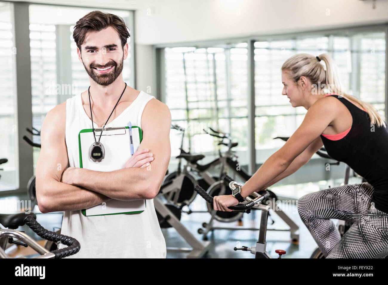 Smiling trainer looking at the camera Stock Photo - Alamy