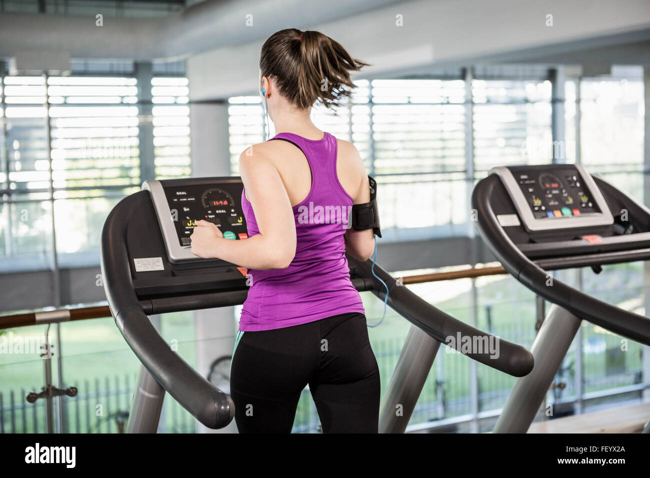 Fit woman running on treadmill Stock Photo - Alamy