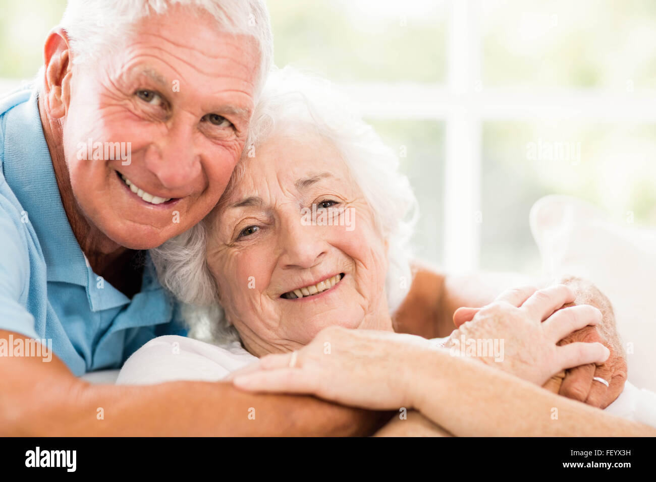 Cute senior couple hugging Stock Photo - Alamy
