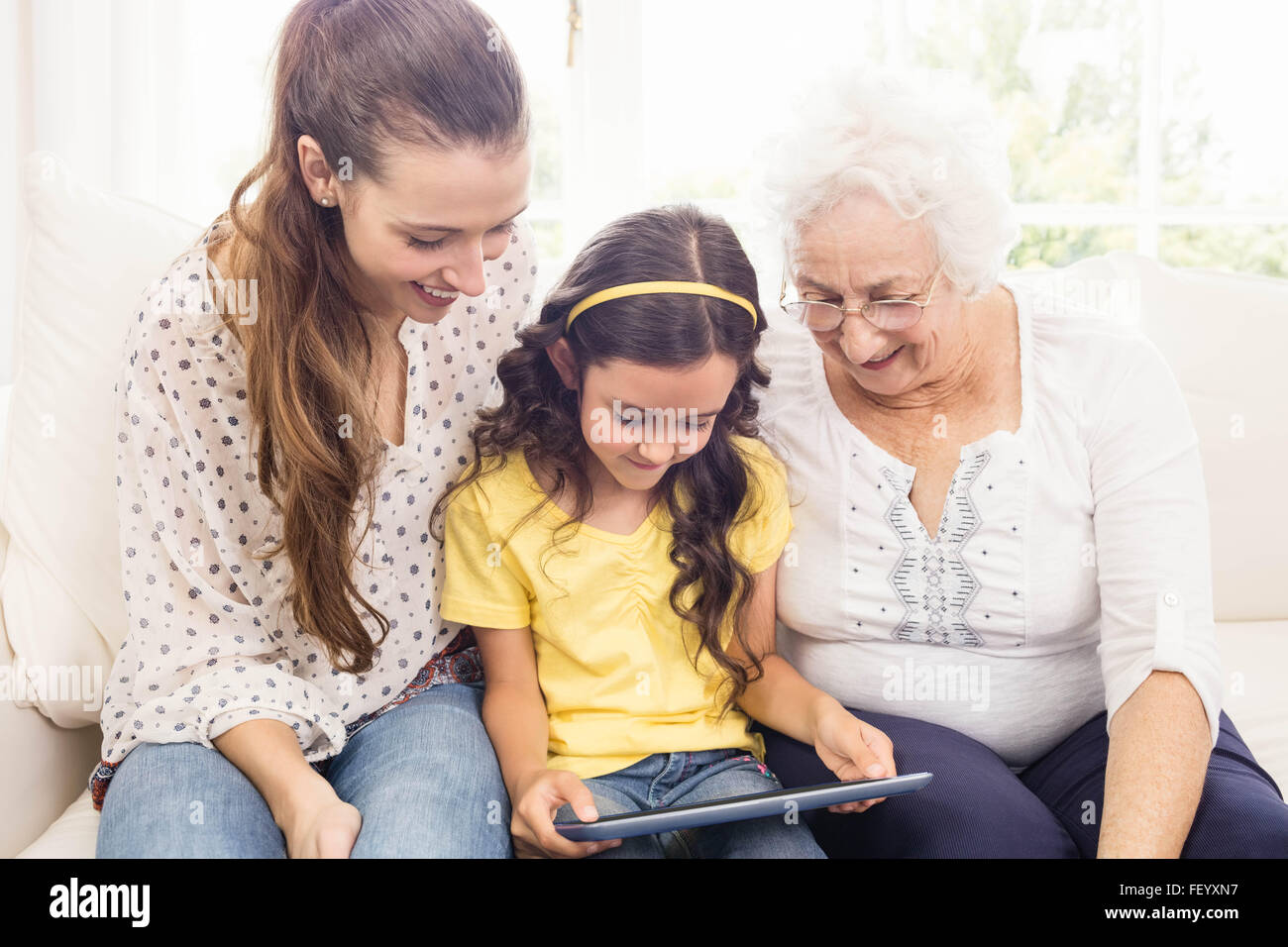 Happy family using tablet Stock Photo - Alamy