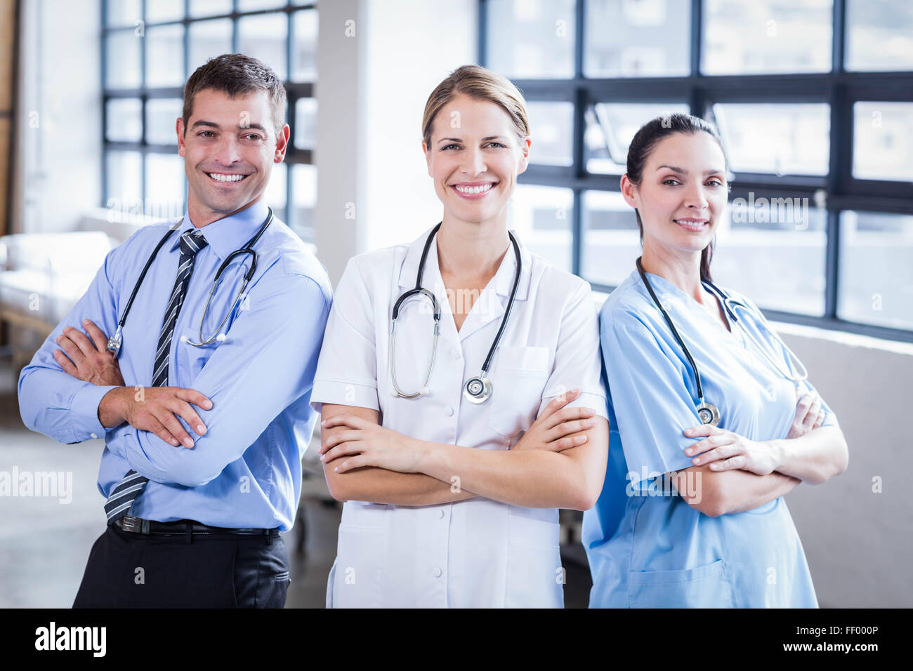 Medical team smiling at camera together Stock Photo - Alamy